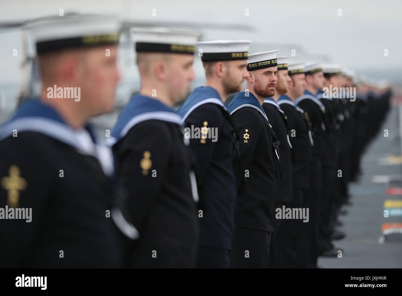 Members of the crew of HMS Queen Elizabeth stand on deck as the UK's ...
