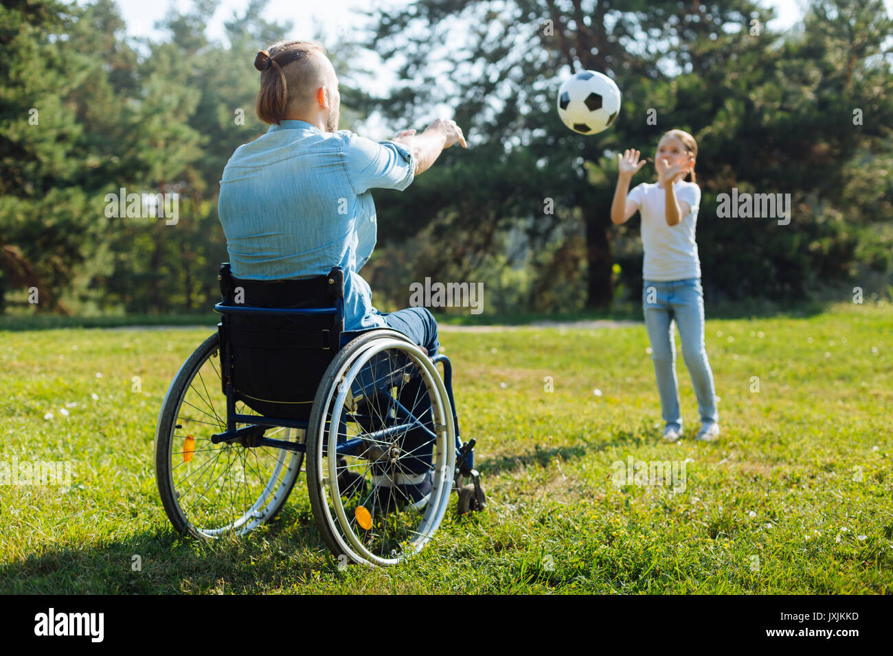 Man with disabilities playing volleyball with daughter Stock Photo - Alamy