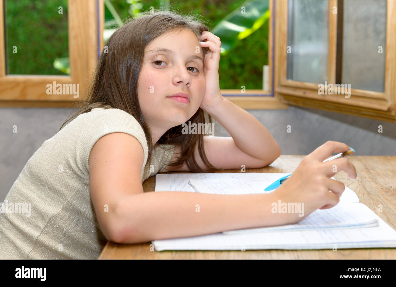 A young teenager doing her homework Stock Photo - Alamy