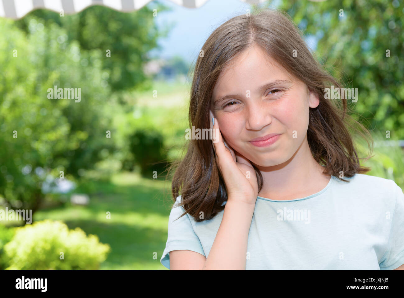 a young girl child an earache, outdoor Stock Photo - Alamy
