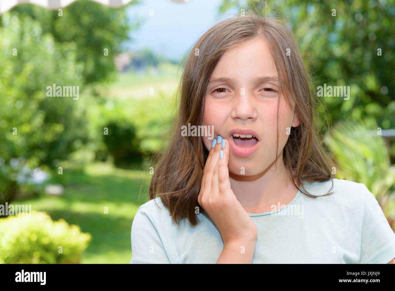 a young cute child girl have a toothache Stock Photo - Alamy