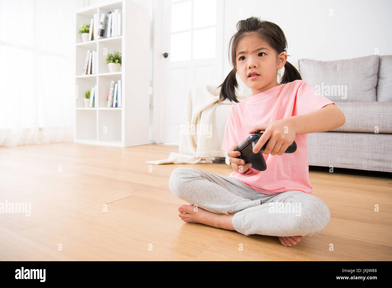 beautiful kid girl children using control joystick seriously playing ...