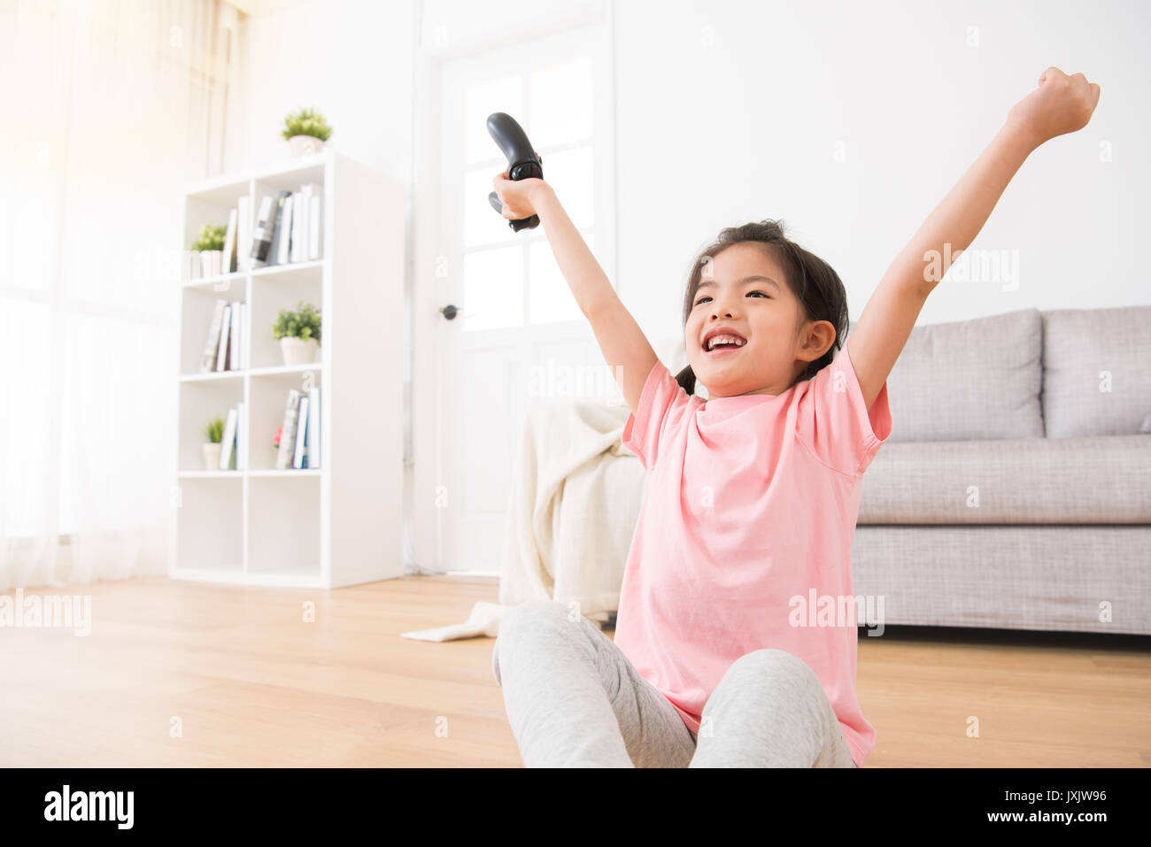 smiling little daughter children holding game joystick controller ...