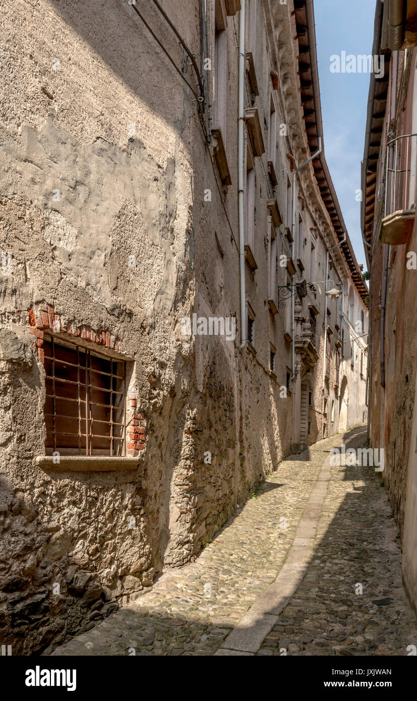 bending cobbled alley in historical village, shot on bright summer day ...