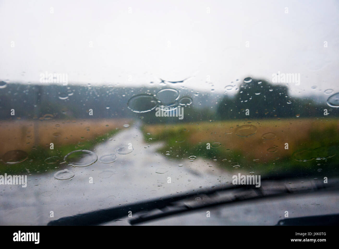 front car window glass and wipers during heavy rain Stock Photo - Alamy