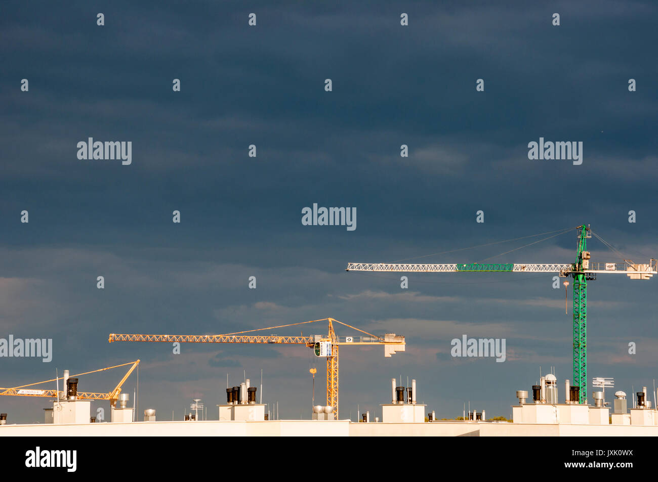 Construction cranes stormy sky hi-res stock photography and images - Alamy