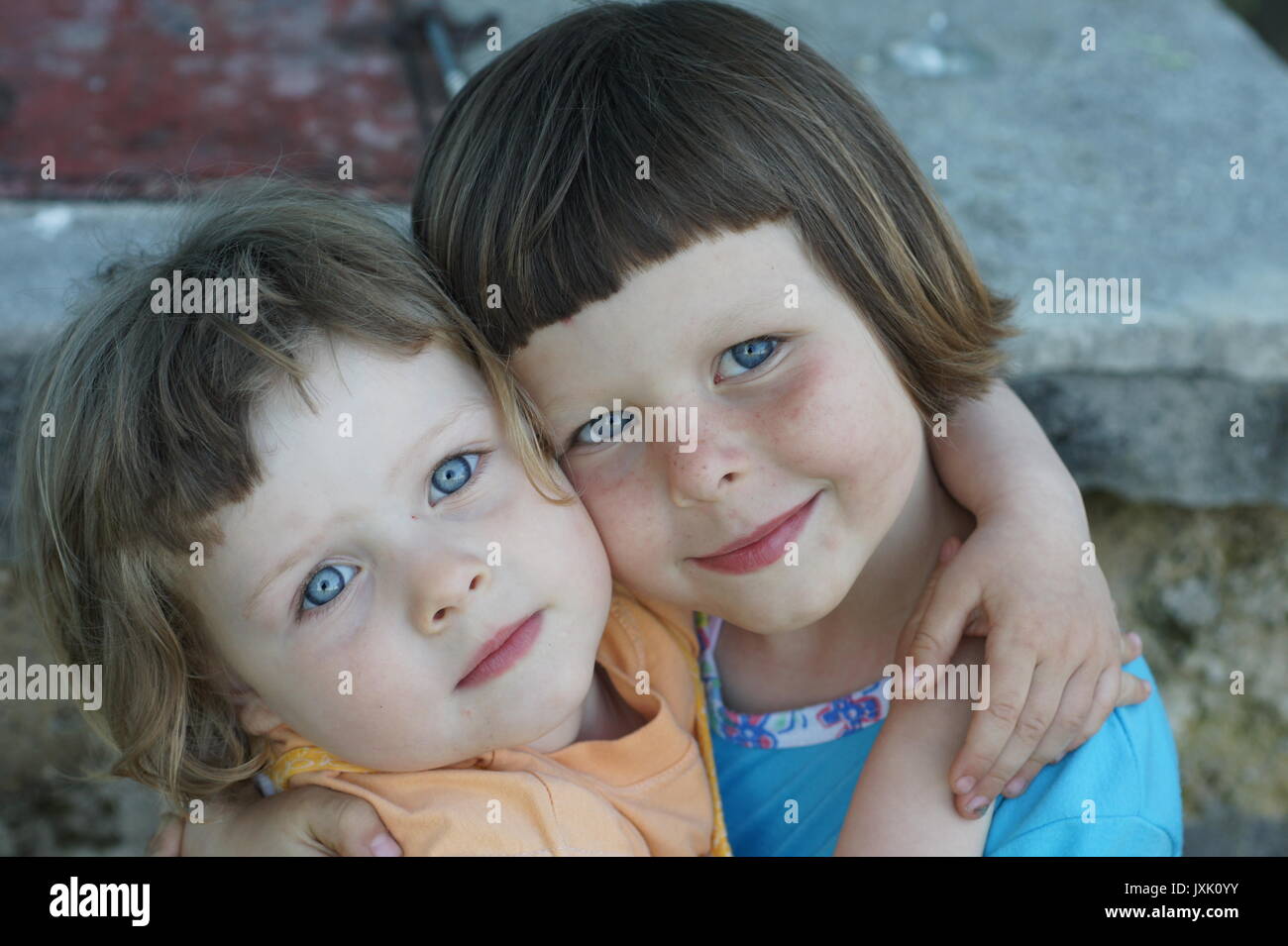 Girls with the blue eyes hugging Stock Photo - Alamy