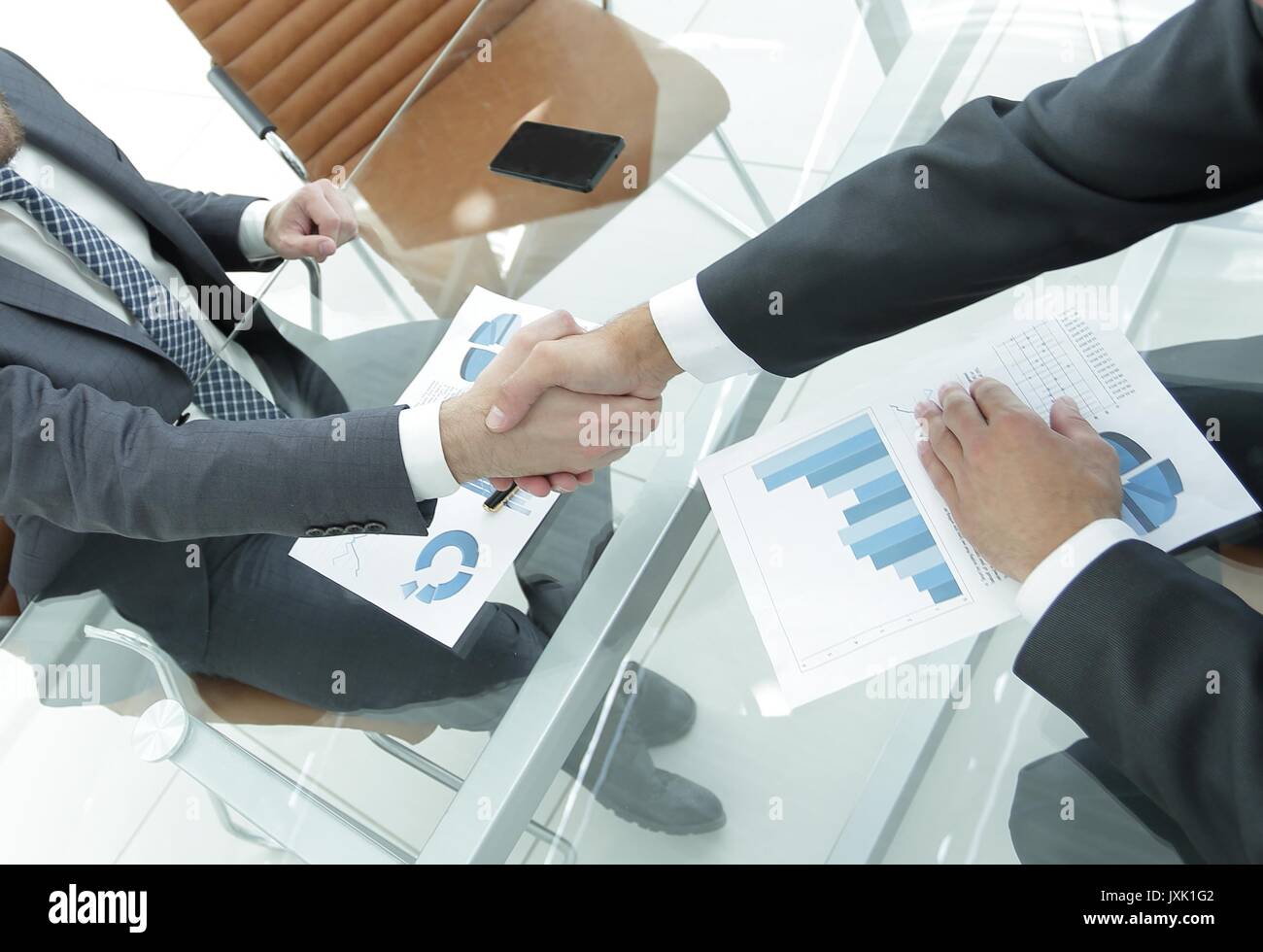 handshake business partners at your Desk Stock Photo - Alamy