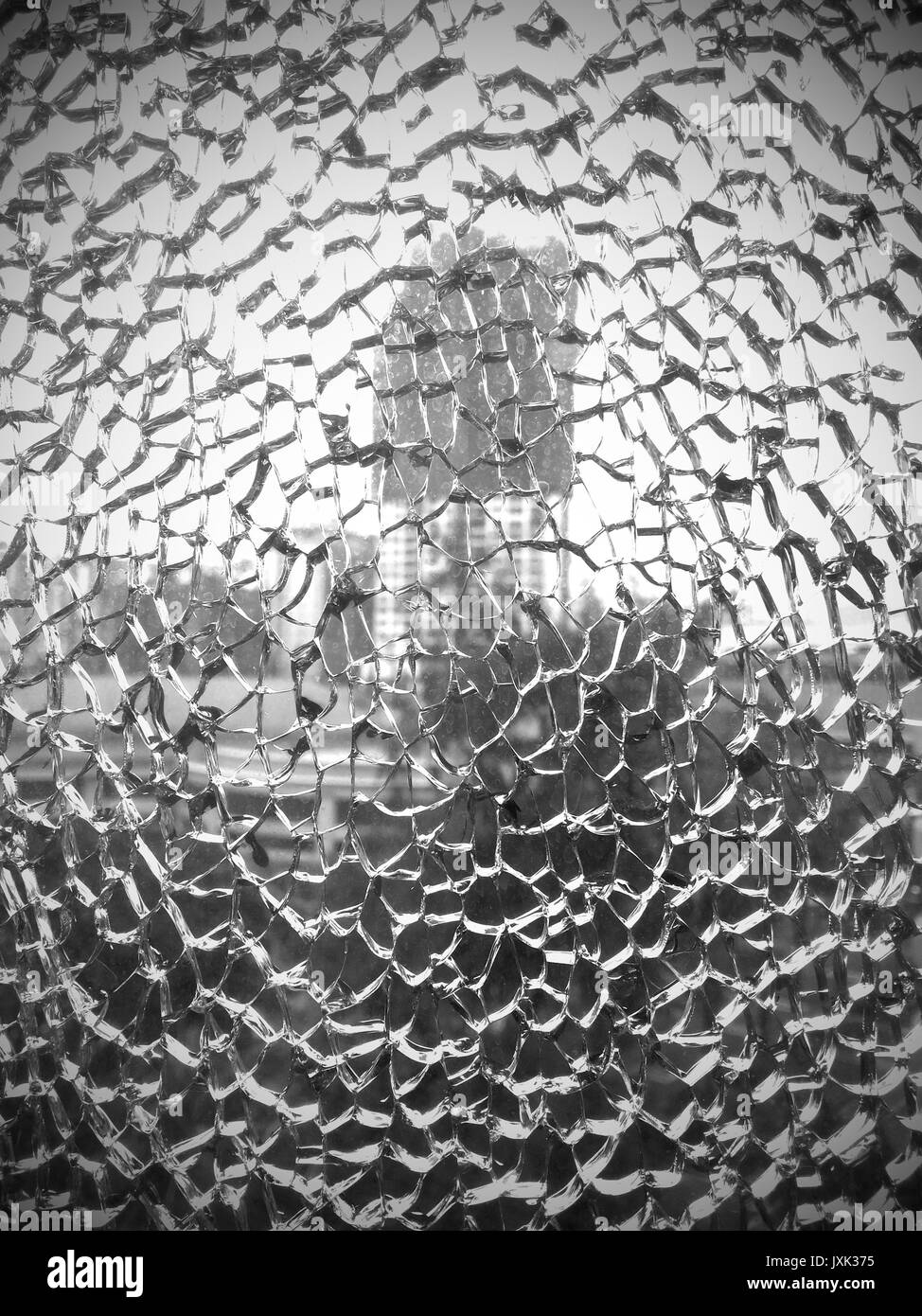A glass window hit by bullet shows its crack Stock Photo - Alamy