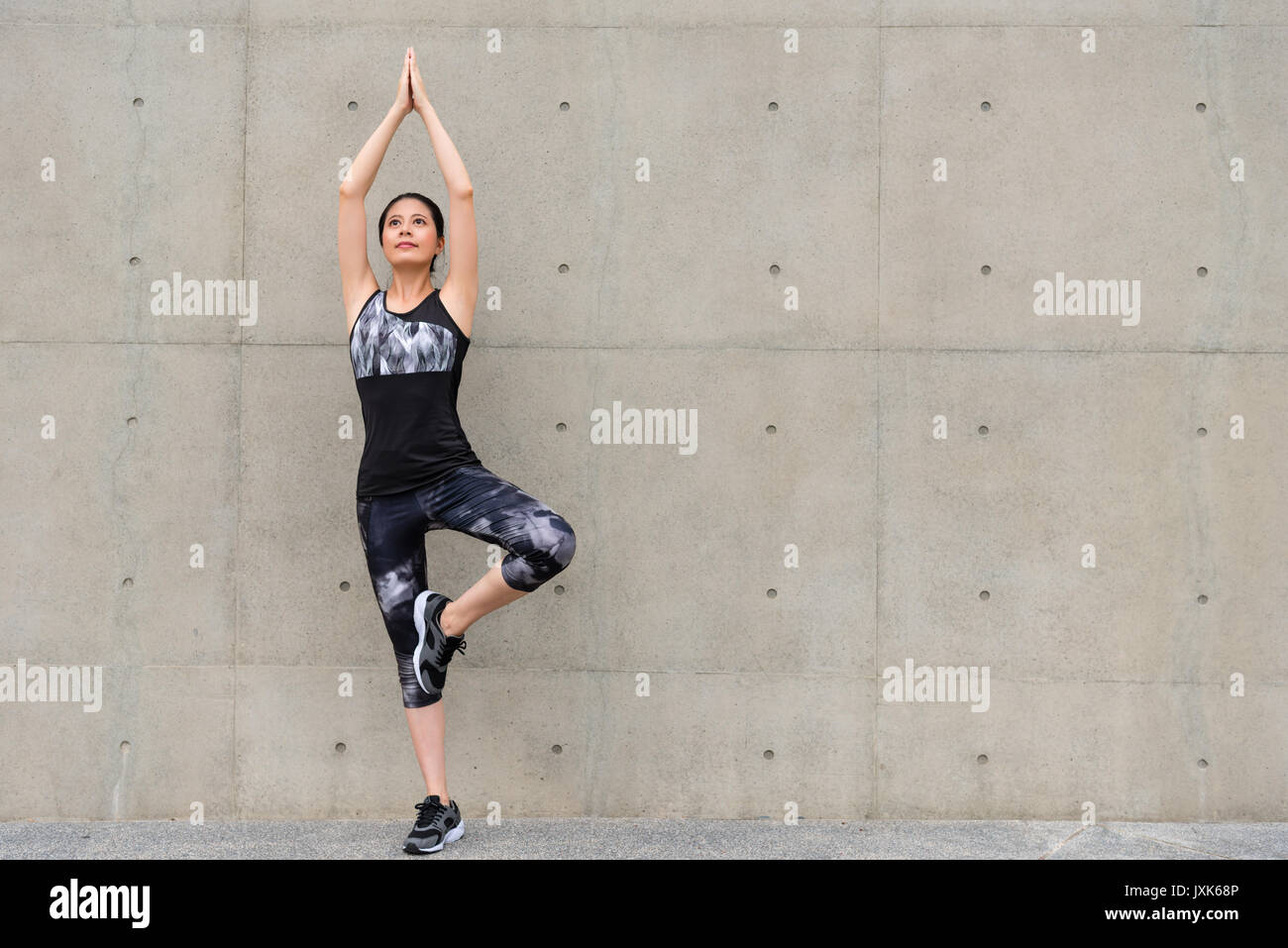 leisurely smiling elegant female jogger showing yoga pose stretching ...