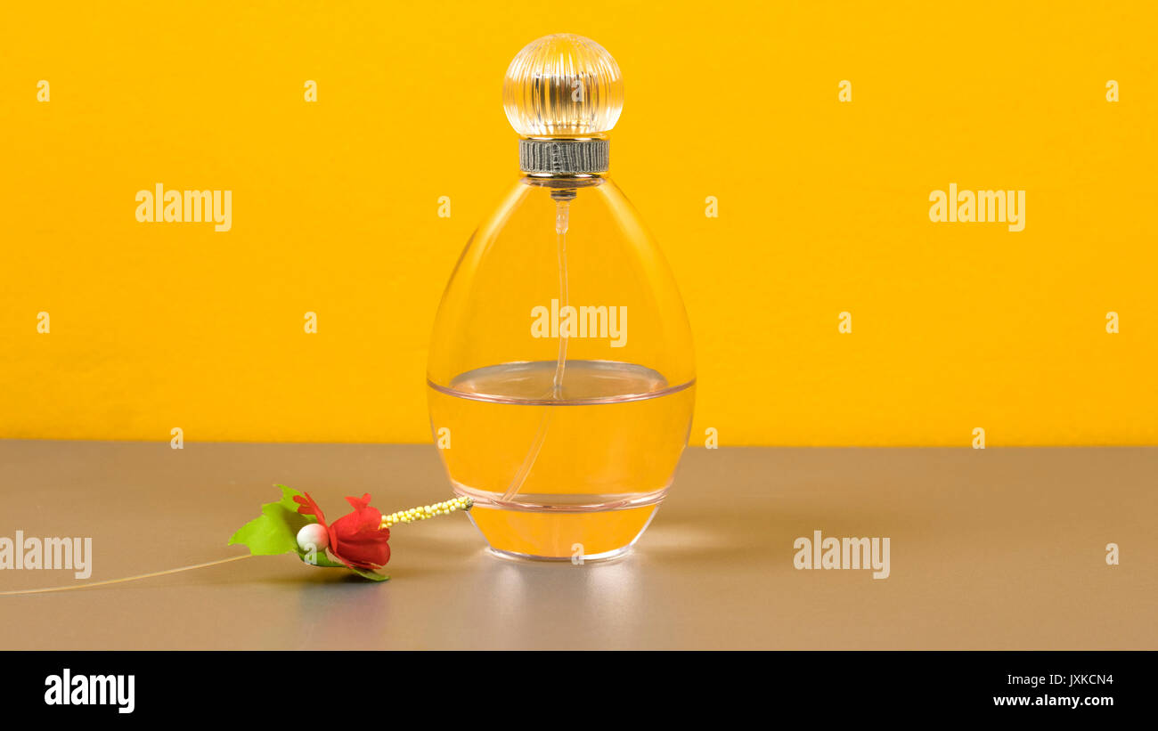 Orange Colour Perfume Bottle with a flower Stock Photo - Alamy