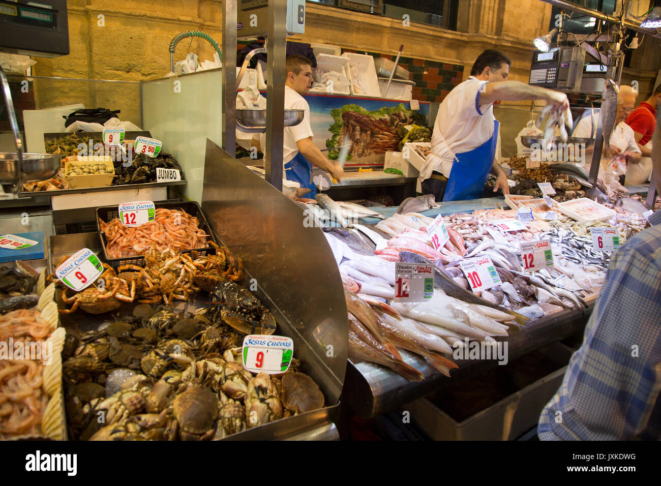 People shopping at fishmonger stalls inside historic covered market ...