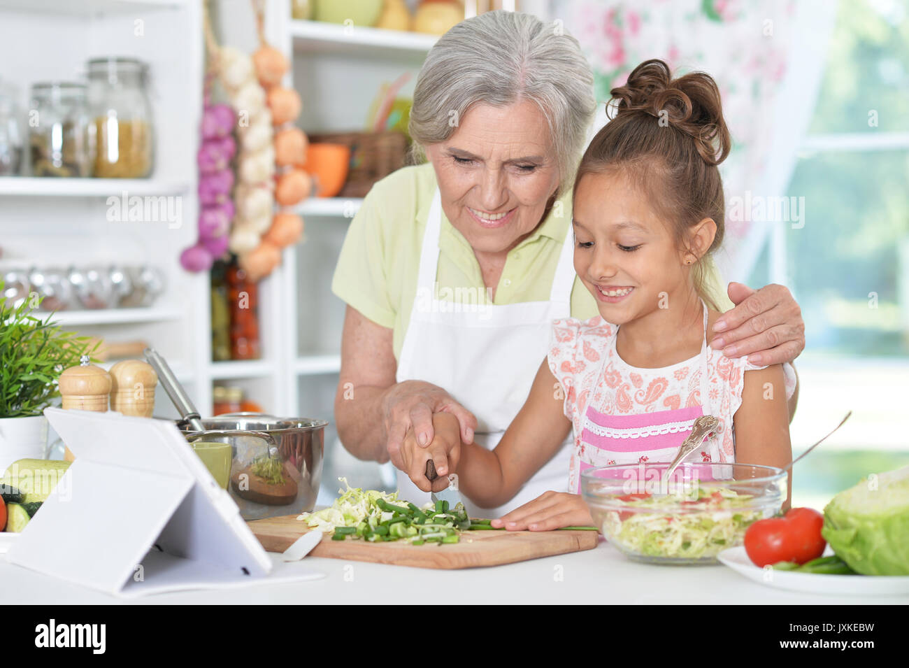 grandmother and granddaughter preparing dinner Stock Photo - Alamy