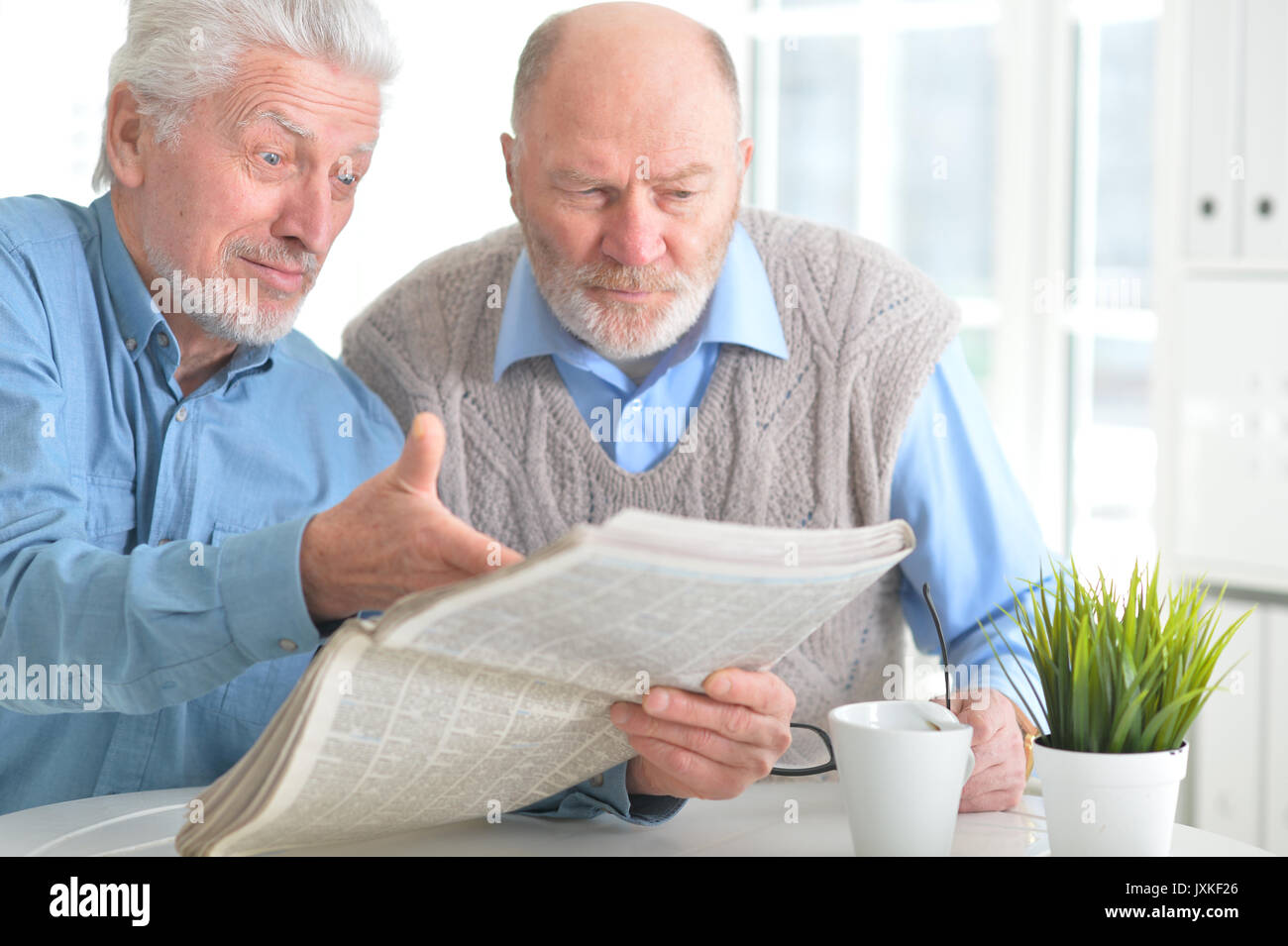 senior men reading newspaper Stock Photo - Alamy