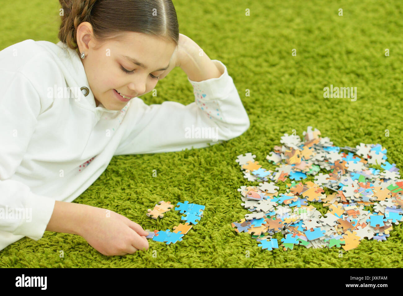 girl collecting puzzle pieces Stock Photo - Alamy