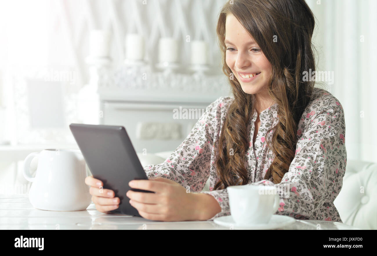 Little girl using tablet Stock Photo - Alamy