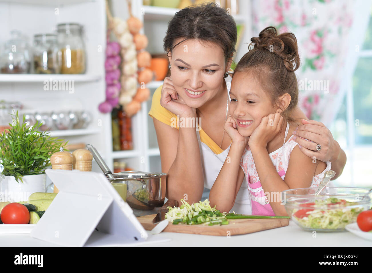 Mother and daughter cooking together Stock Photo - Alamy