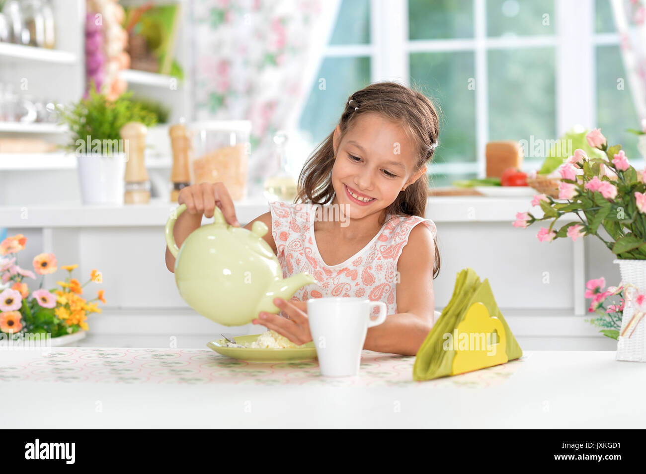 Little girl pouring tea Stock Photo - Alamy