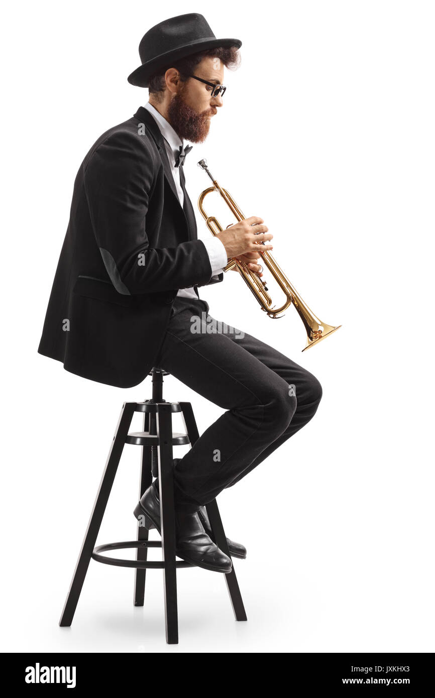 Profile shot of a trumpet player seated on a chair isolated on white ...