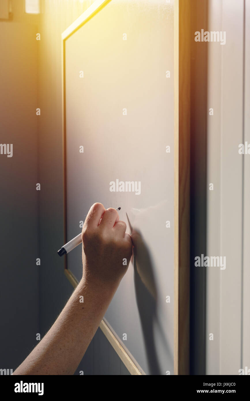 Hand writing on whiteboard surface - office, business and education ...