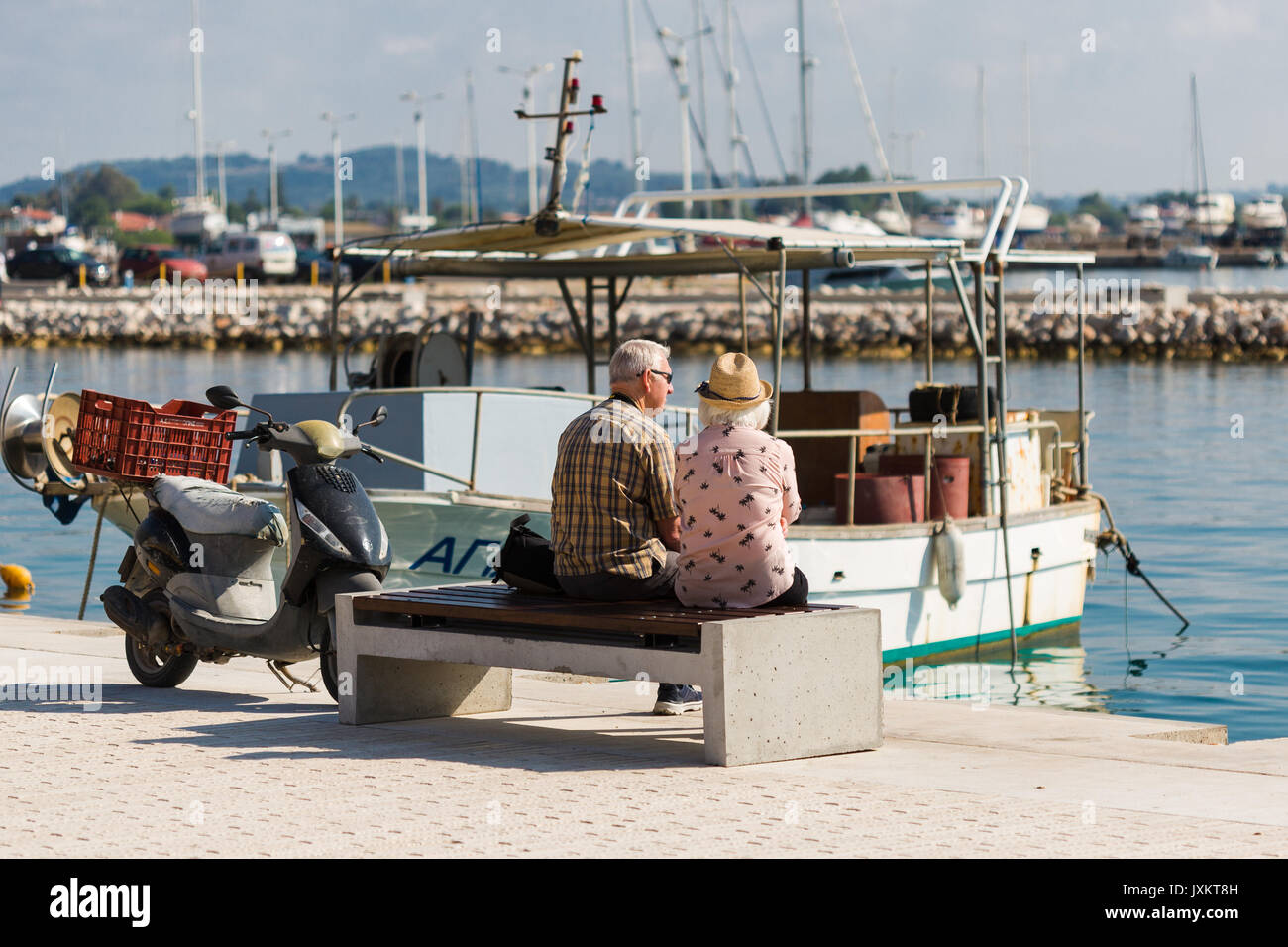 Katakolon, Greece. Gateway to Olympia. Couple enjoying morning sunshine ...