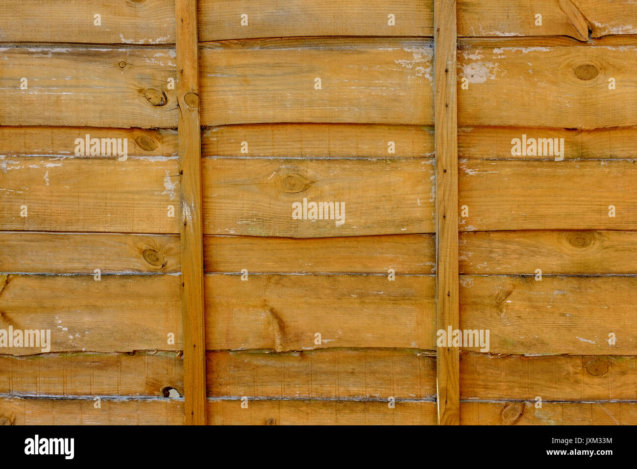 Section of a yellow stained panel fence Stock Photo - Alamy