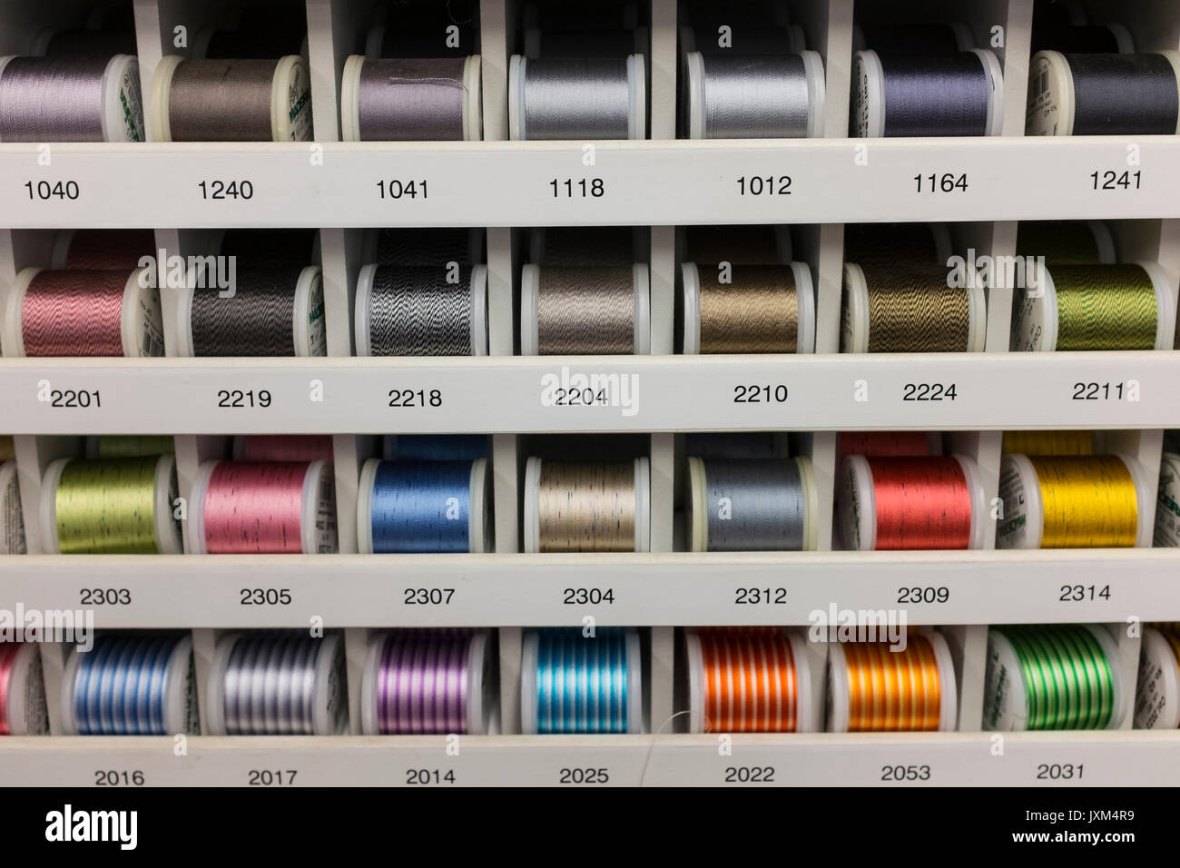 Rack of colourful cotton reels Stock Photo - Alamy