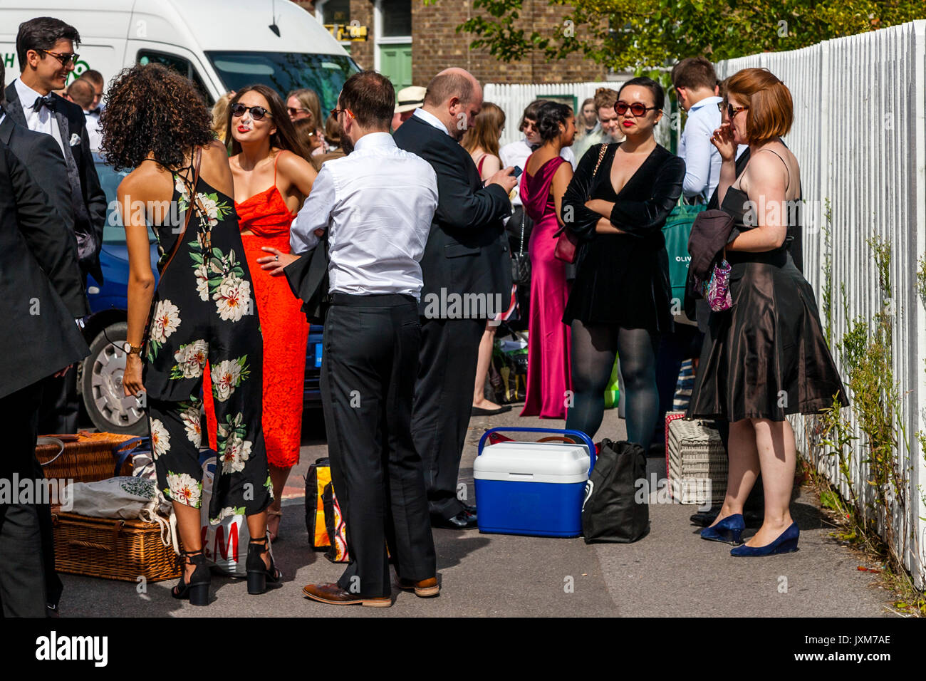 Young opera fans wait to board a bus to Glyndebourne Opera House for a ...