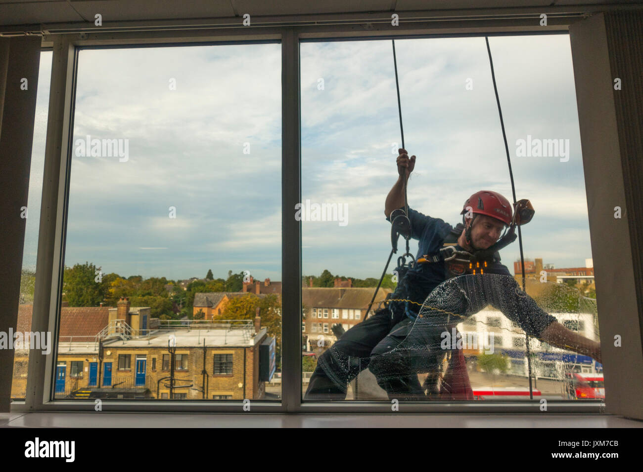 Men cleaning office windows at great height Stock Photo - Alamy