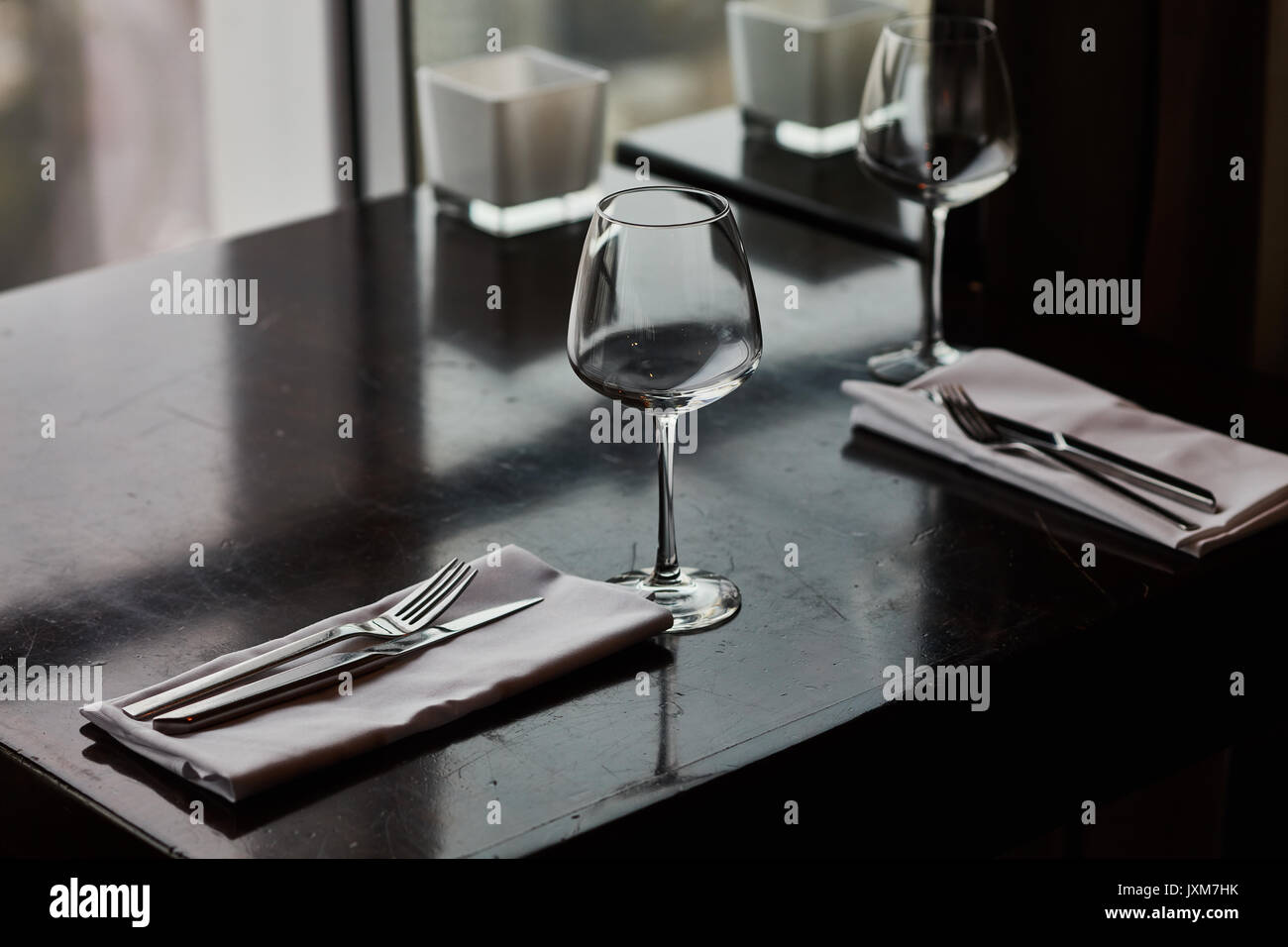 Dining table served with glasses, forks and knifes Stock Photo - Alamy