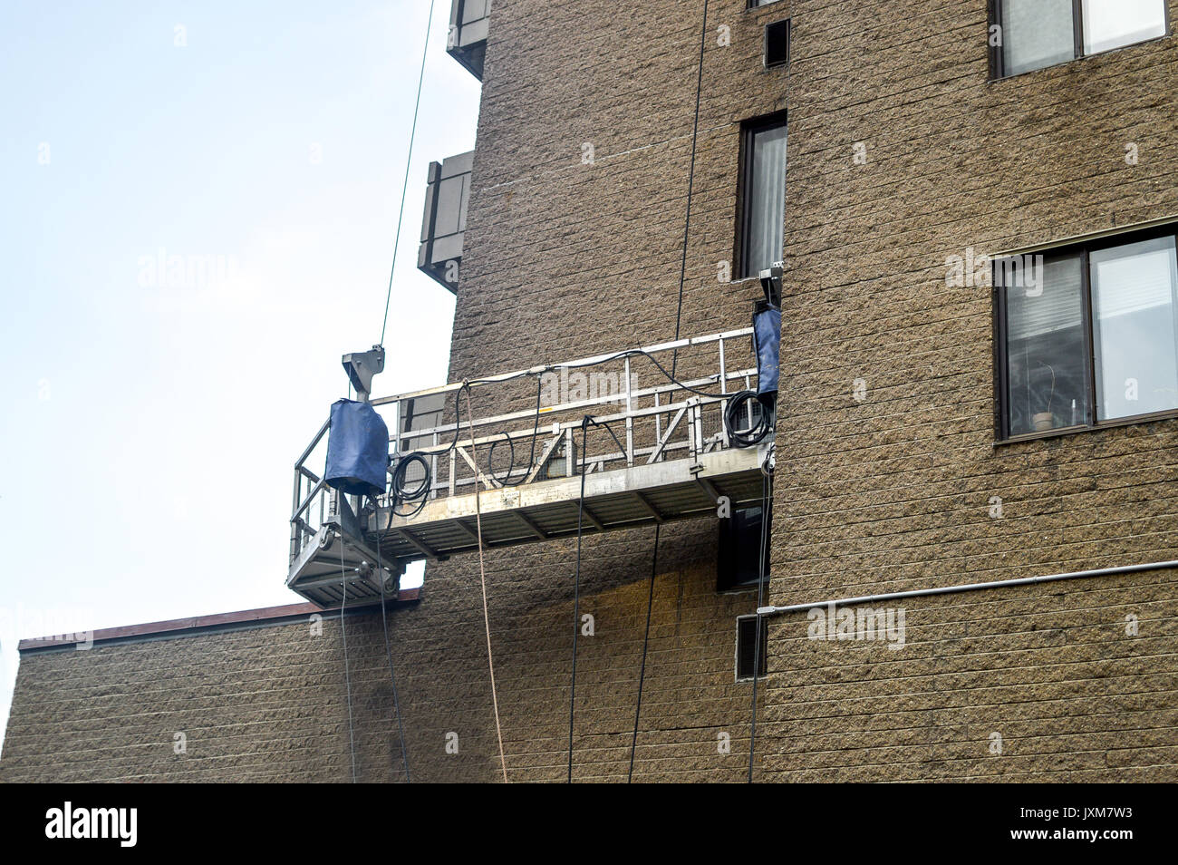 Facade cleaning elevator for big buildings on building background in ...