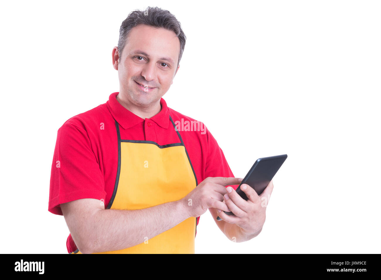 Smiling male staff using digital tablet in supermarket and doing online ...