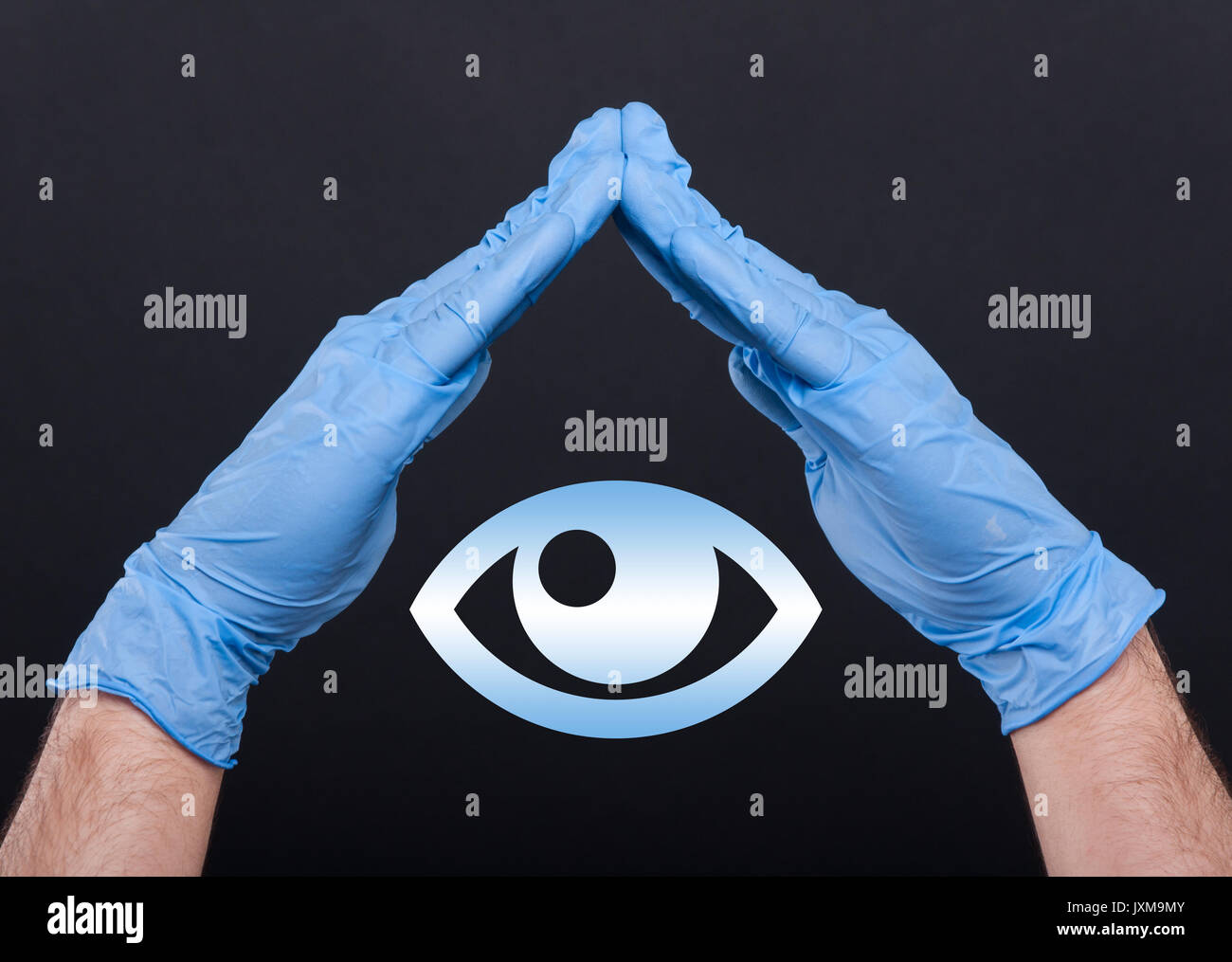 Medical doctor with eye symbol between hands as ophtalmology concept ...