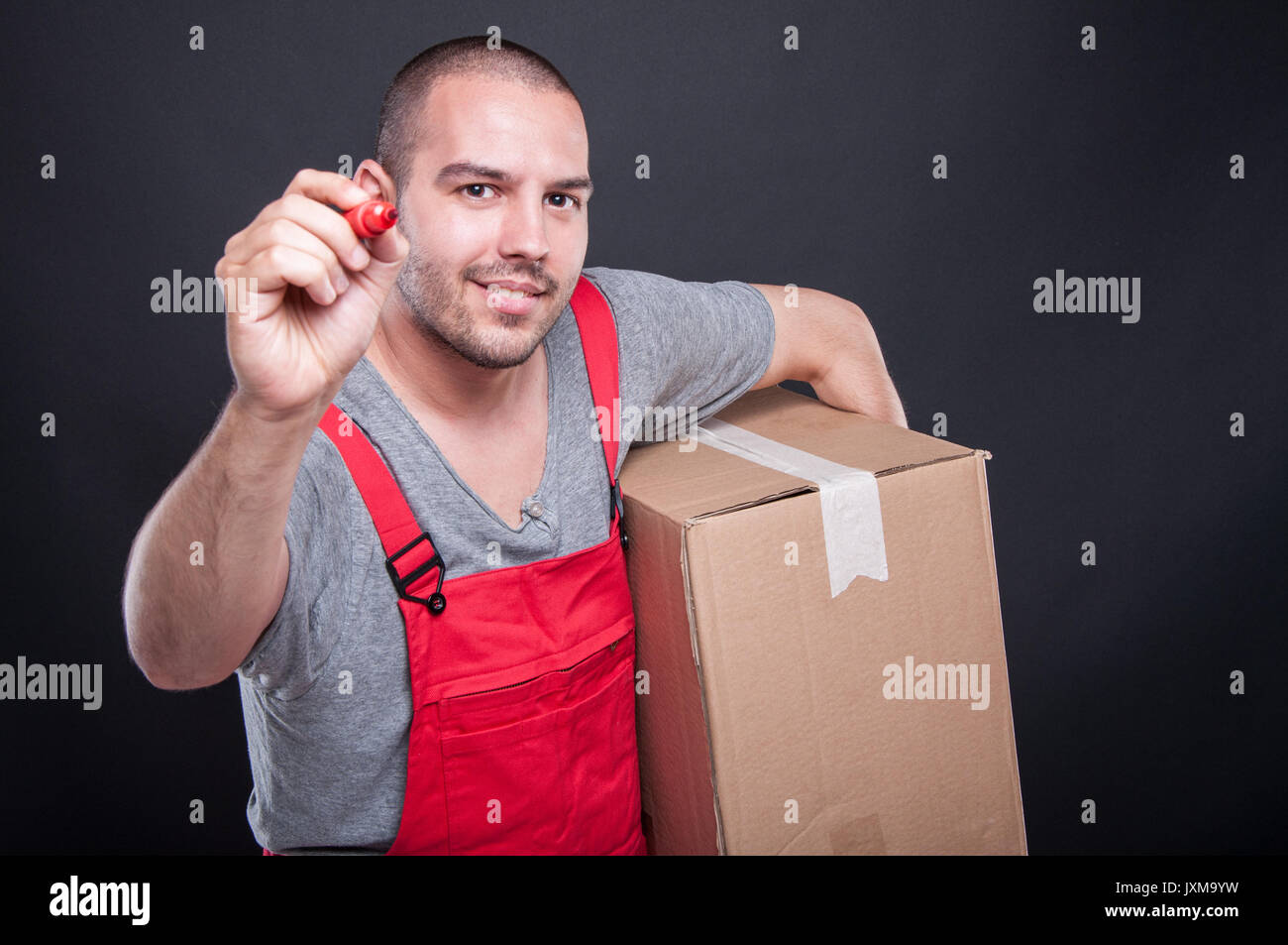 Mover guy holding box writing with red marker on black background Stock ...