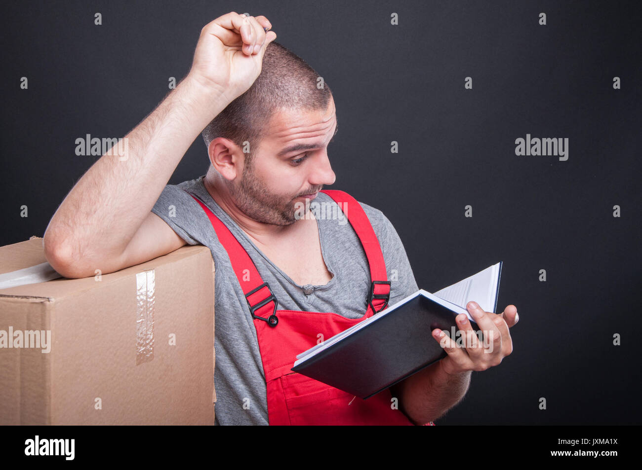 Mover guy holding agenda making thinking gesture scratching with his ...