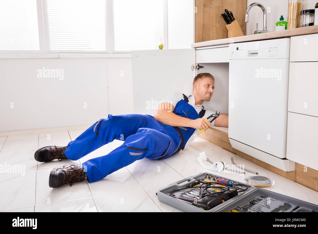 Handyman in kitchen house hi-res stock photography and images - Alamy