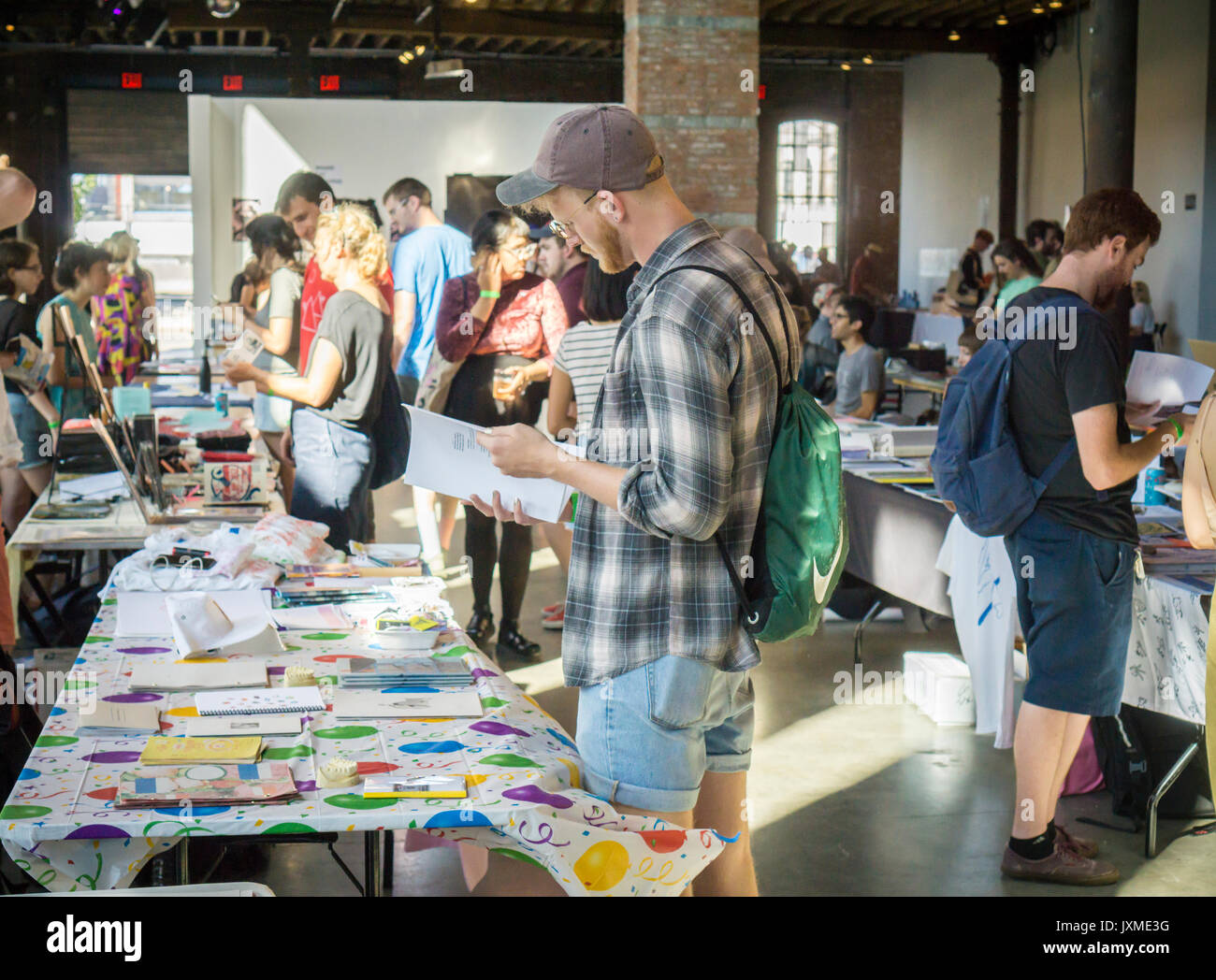 Visitors browse the exhibitors' booths at the Press Play Fair in the ...
