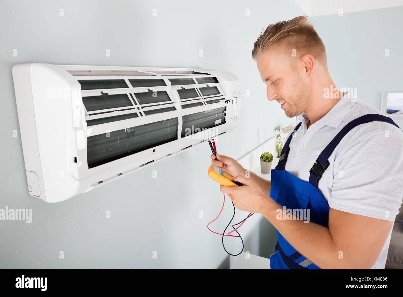 Male Electrician Checking Air Conditioner With Digital Multimeter Stock ...