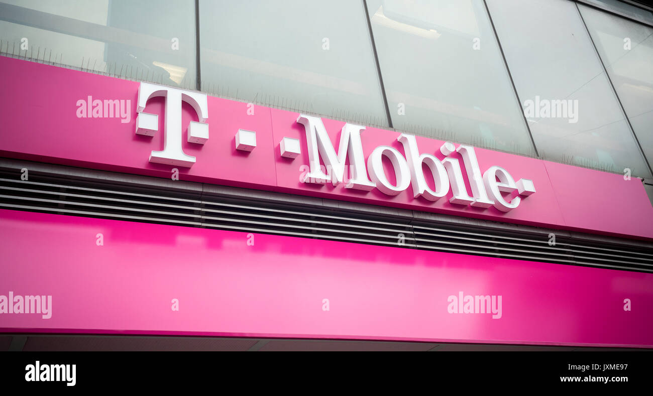 The magenta sign of a T-Mobile USA store is seen in New York on Sunday ...