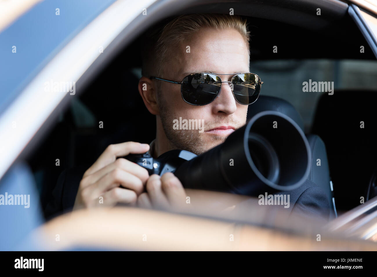 Private Detective Sitting Inside Car Photographing With SLR Camera ...