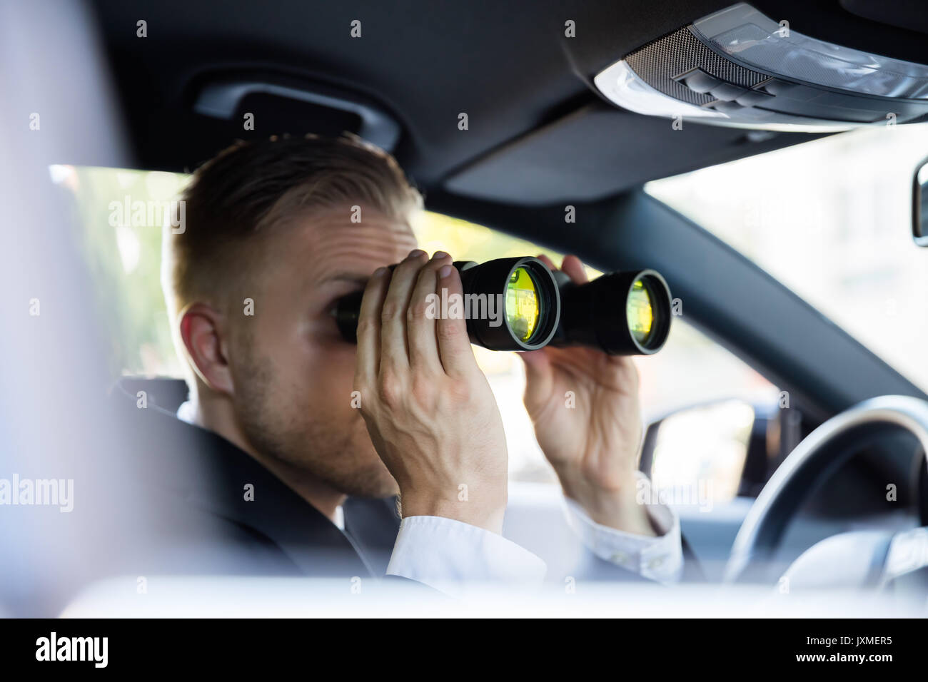 Sitting man binocular hi-res stock photography and images - Alamy