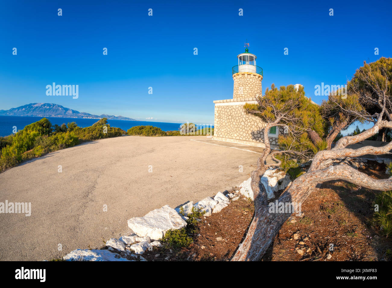 Skinari Lighthouse against Kefalonia island on Zakynthos island, Greece ...