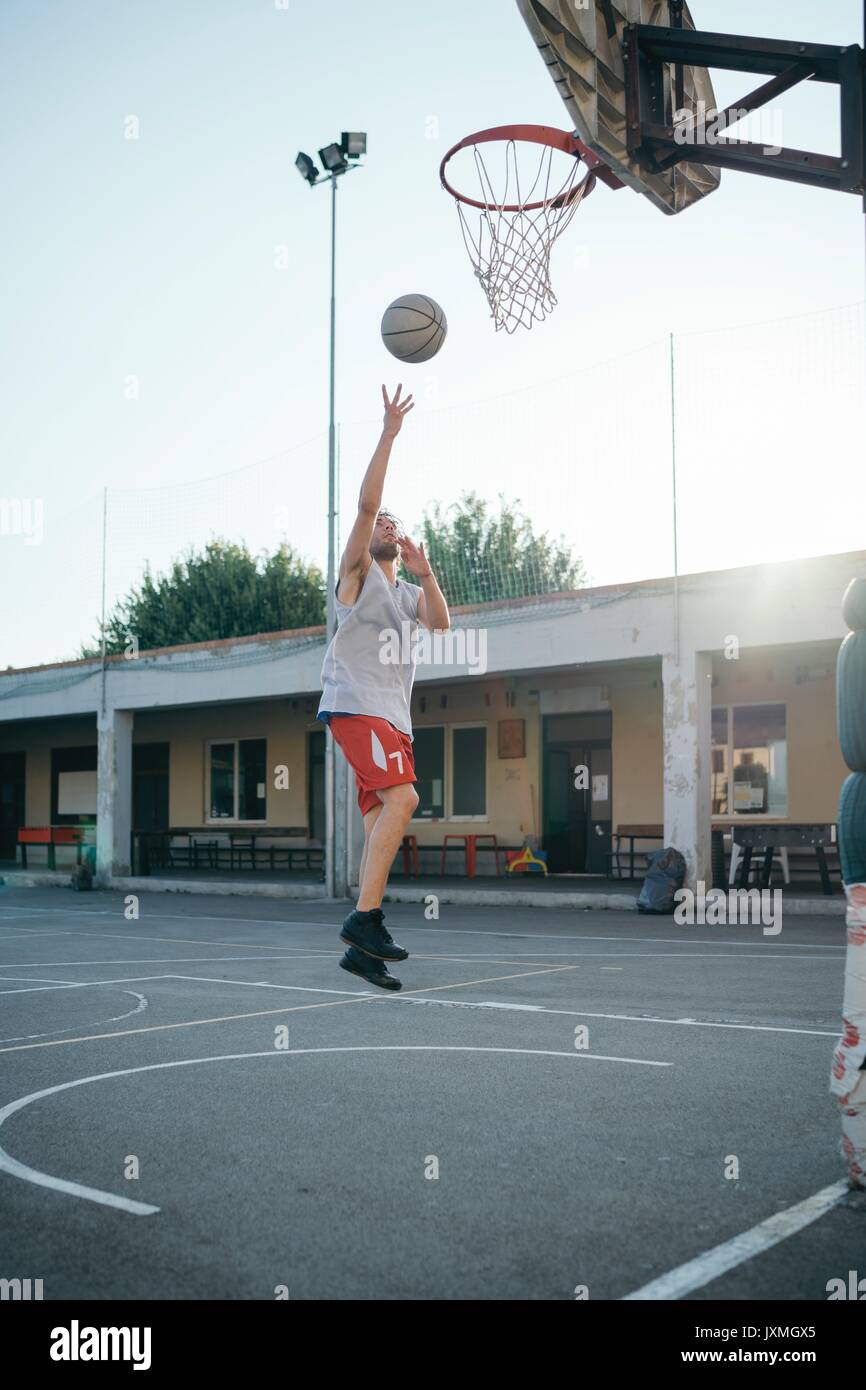 Man jumping for basketball hoop Stock Photo - Alamy