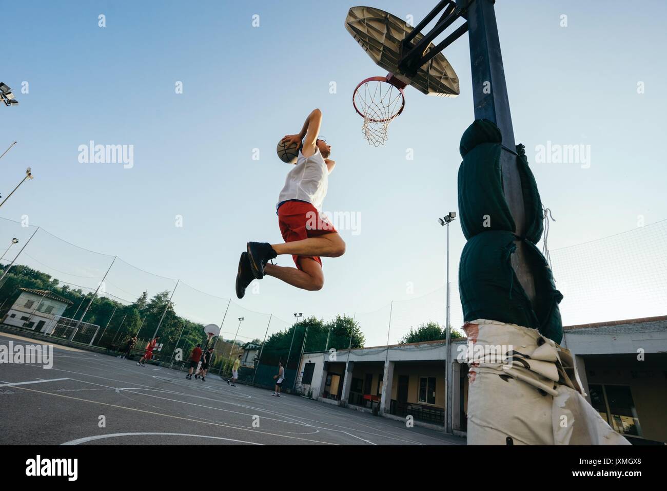 Man jumping for basketball hoop Stock Photo - Alamy