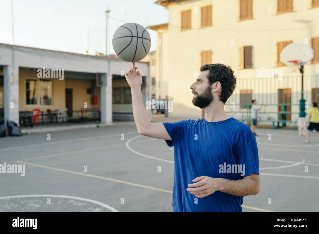 Man spinning basketball on finger Stock Photo - Alamy
