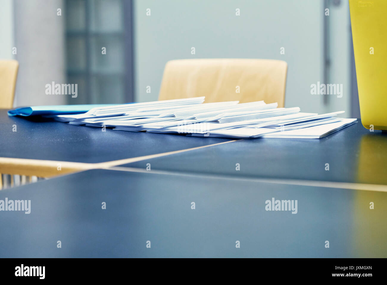 Row of paperwork on boardroom table Stock Photo - Alamy