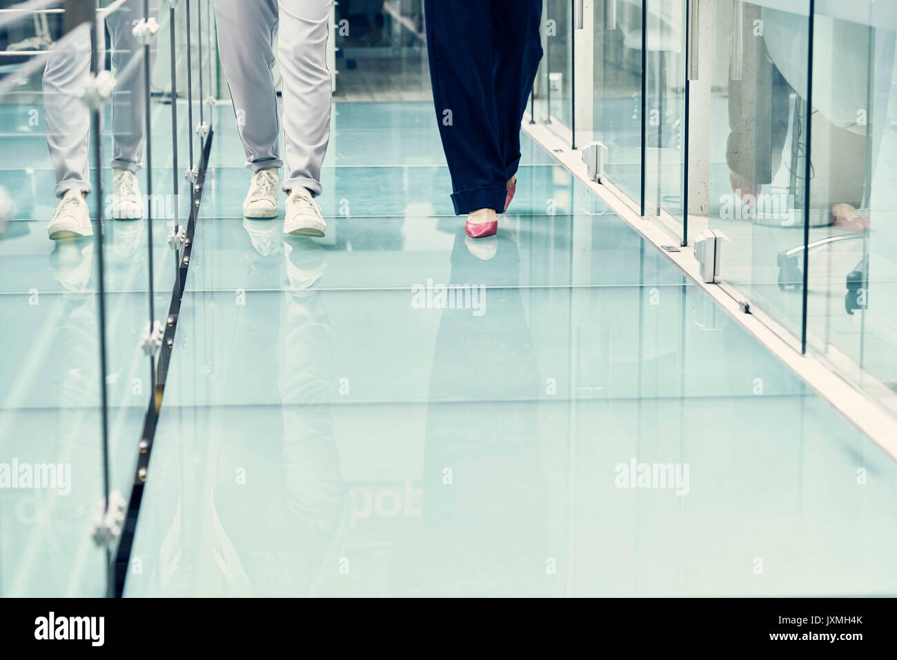 Businesswomen walking along corridor of office Stock Photo - Alamy