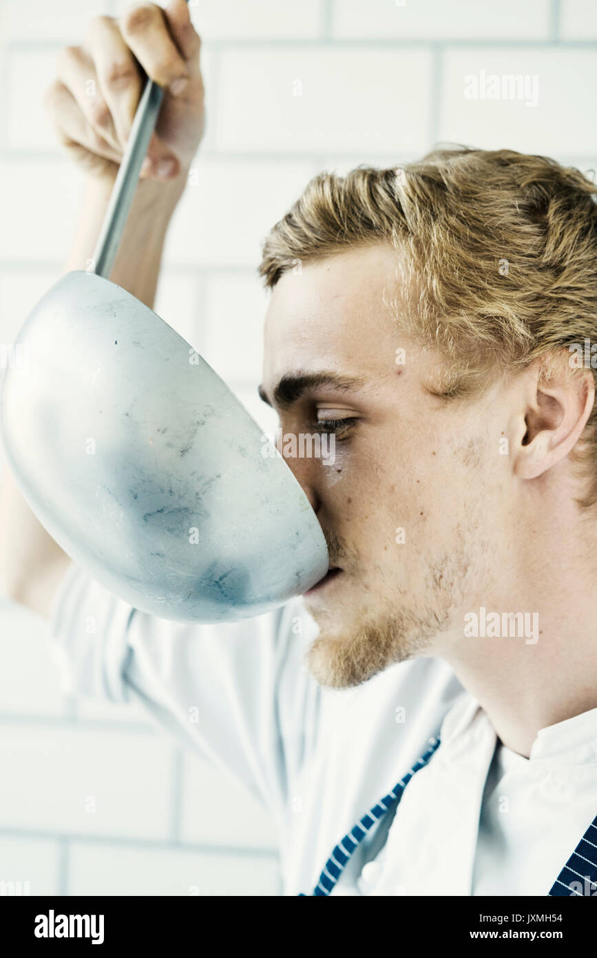 Chef drinking from ladle Stock Photo - Alamy