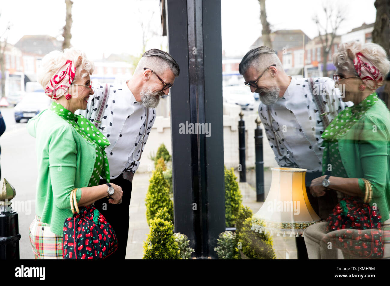Quirky vintage couple window shopping at vintage shop Stock Photo - Alamy