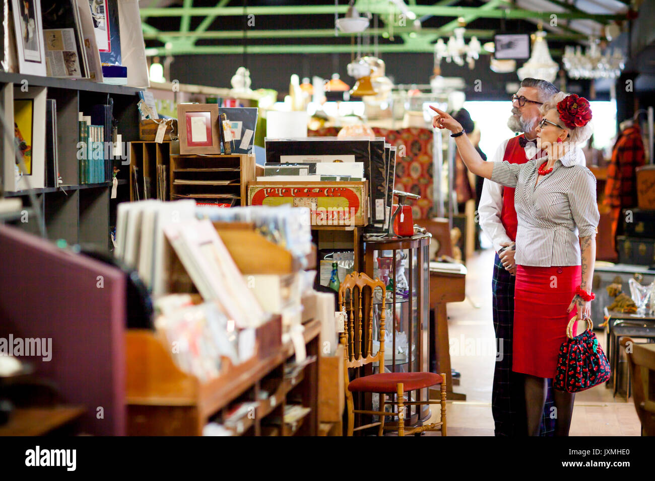 Quirky vintage couple shopping together in antiques emporium Stock ...